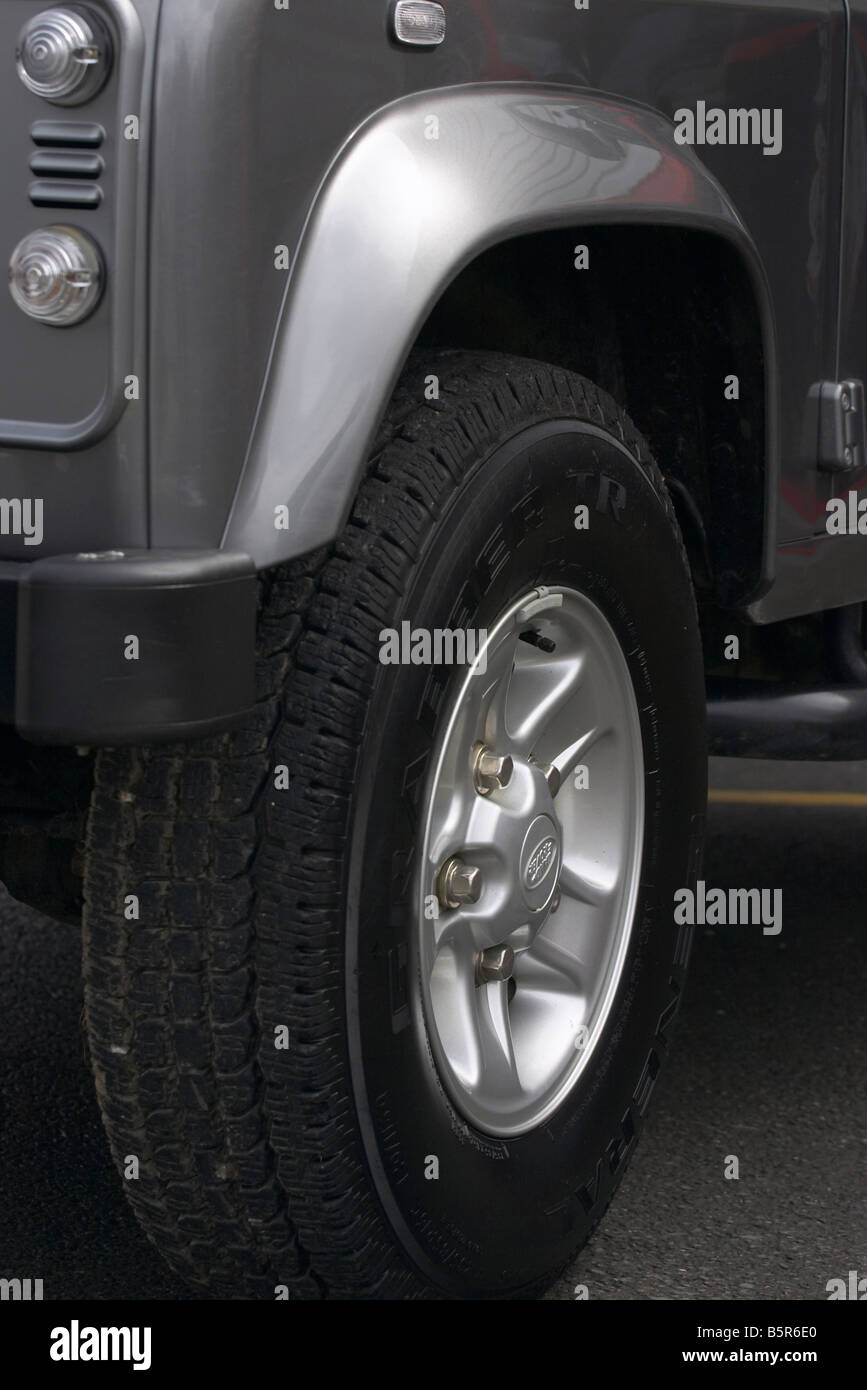 Close up of an alloy wheel and front wing of a grey Land Rover Stock ...