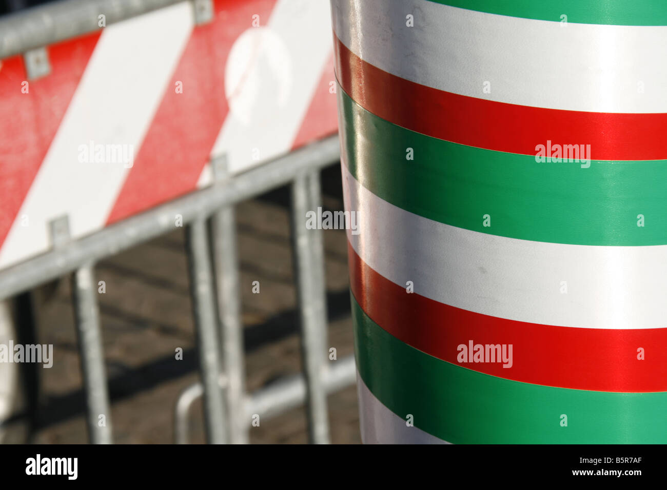 bollard pole with red white and green ribbon stripes Stock Photo - Alamy