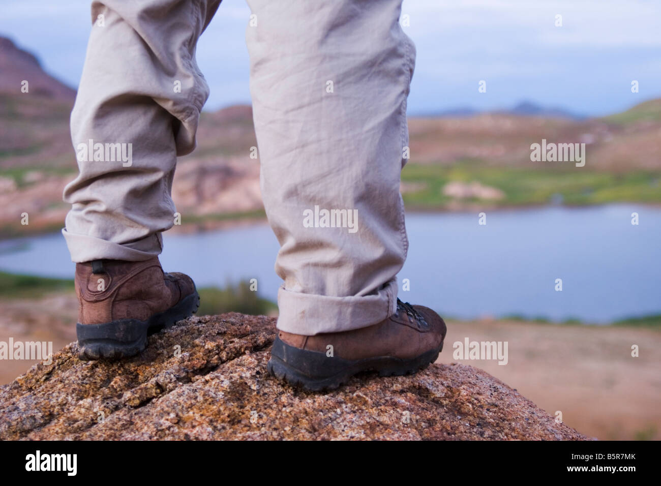 Man standing on a boulder looking down at Upper Emigrant Lake, Emigrant ...