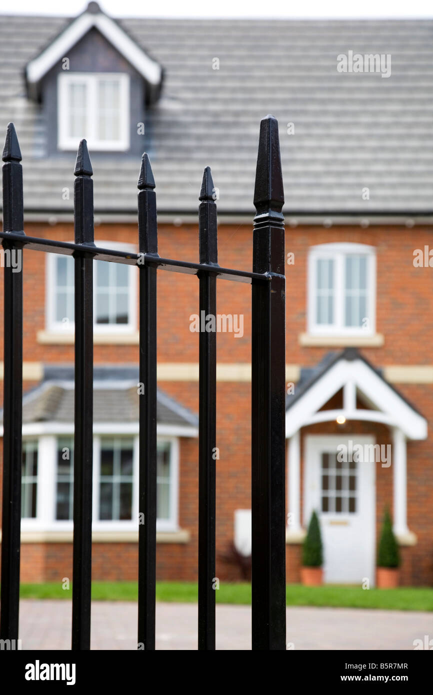 A modern red brick house with security gate Stock Photo - Alamy