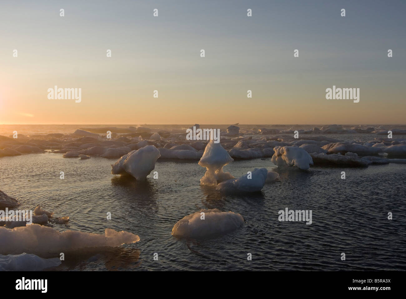 melting shorefast ice in the Beaufort Sea at sunset Arctic Ocean off ...