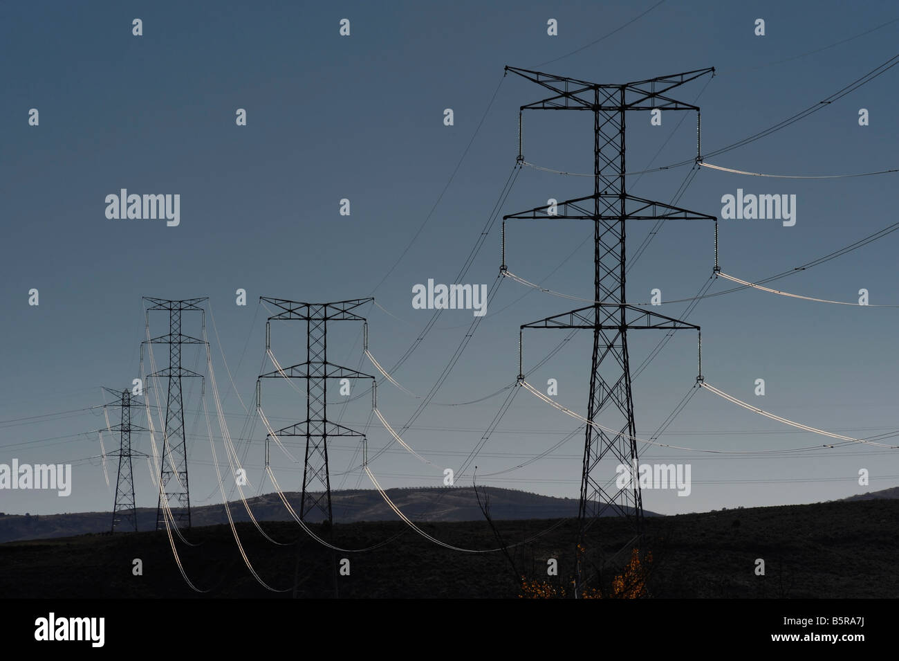 Electricity pylons and power cables stretch over the Spanish landscape ...