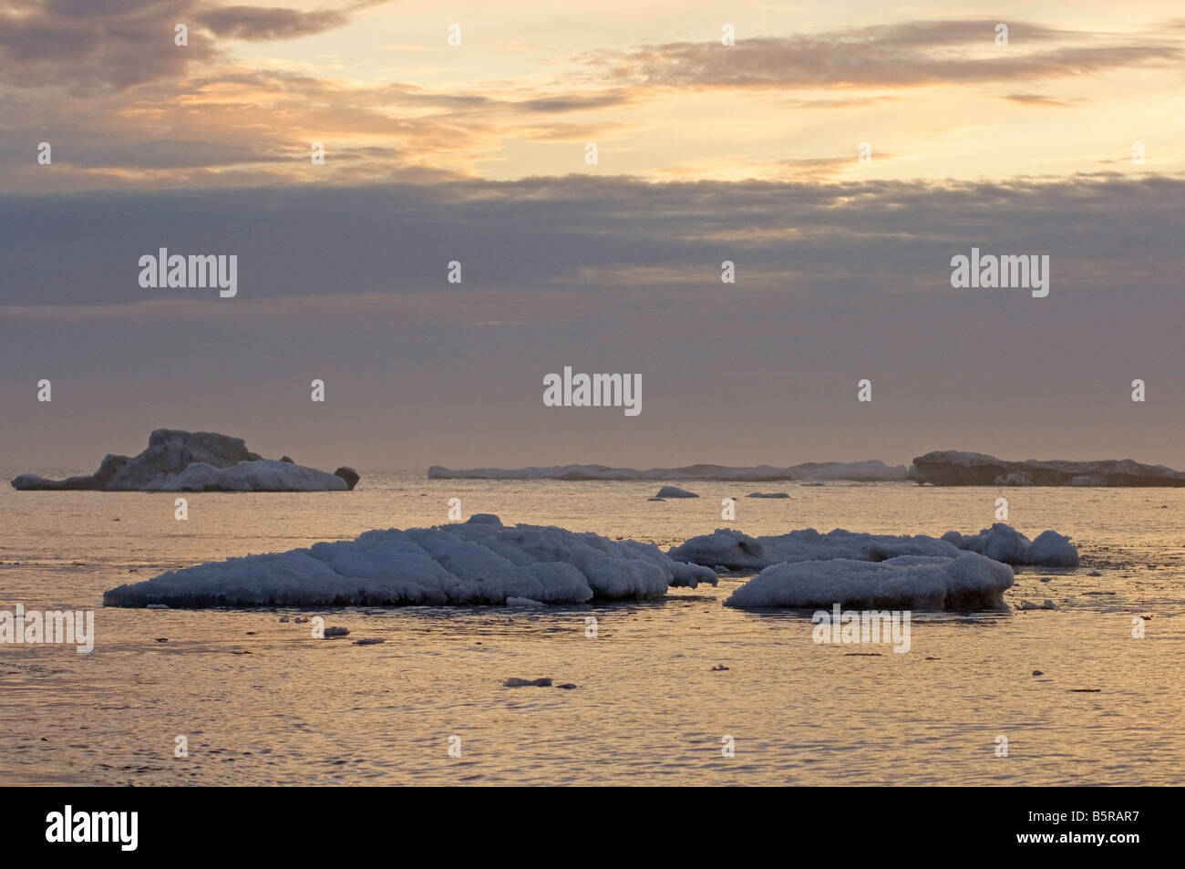 melting shorefast ice in the Beaufort Sea at sunset Arctic Ocean off ...