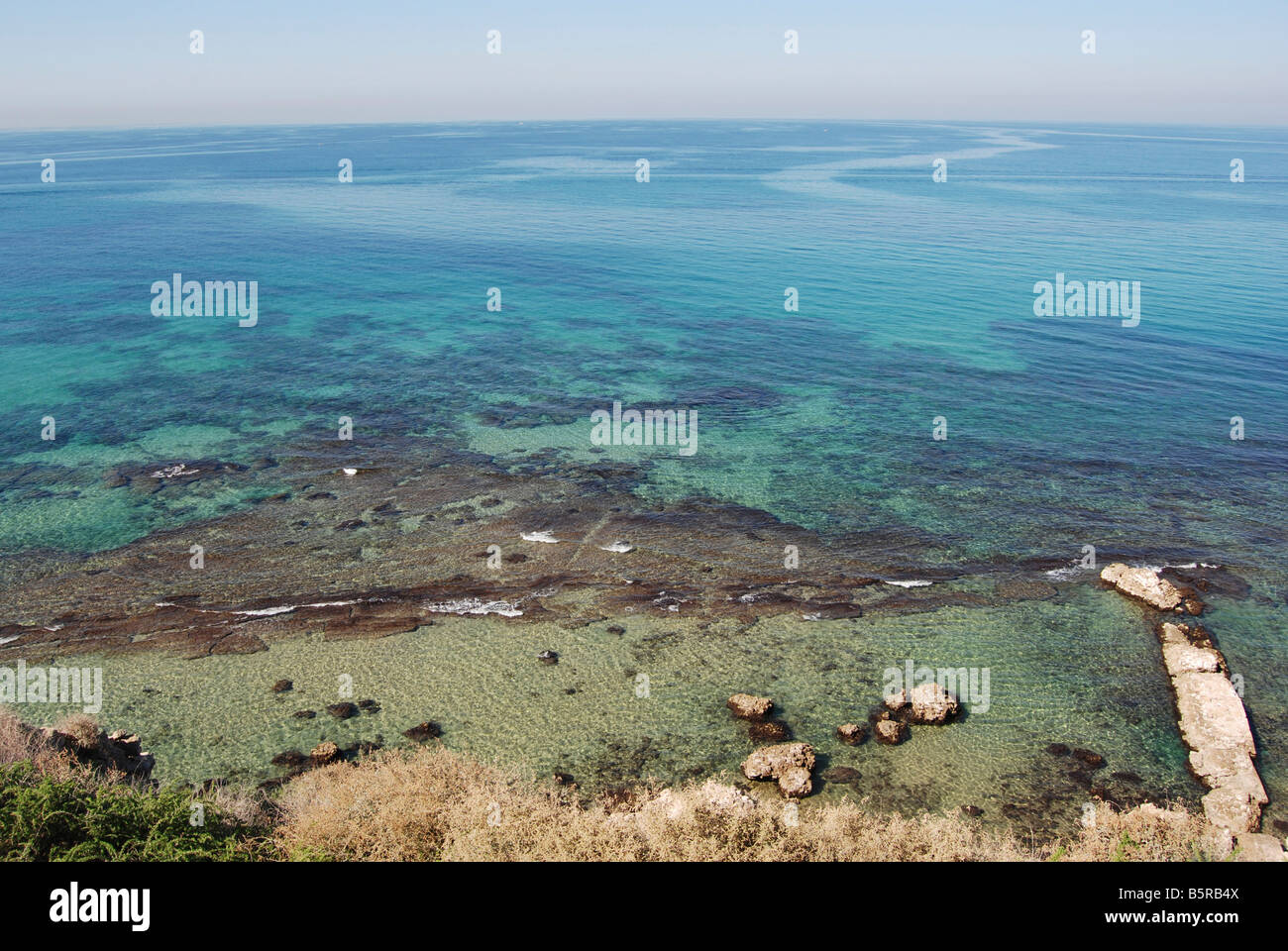 Rocks in the shallow sea Stock Photo - Alamy