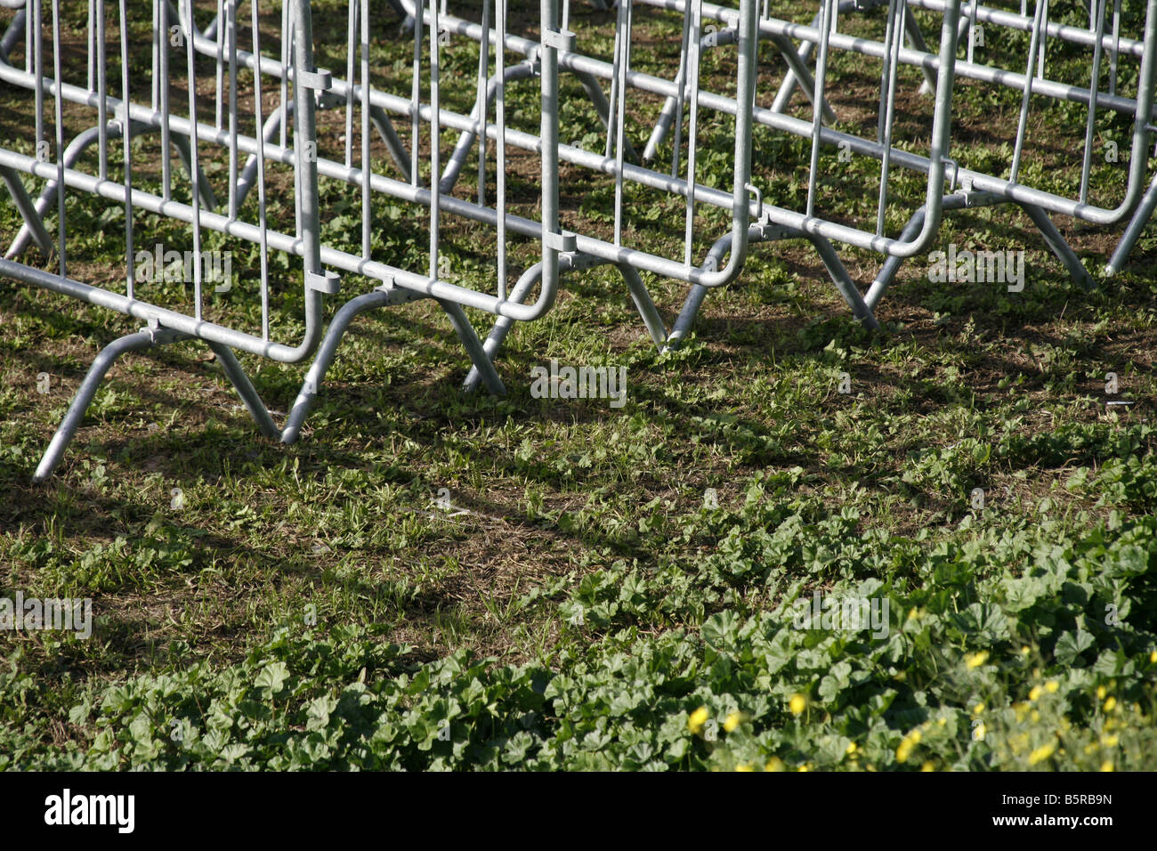 rows of many metal crowd control barriers gates in field Stock Photo ...