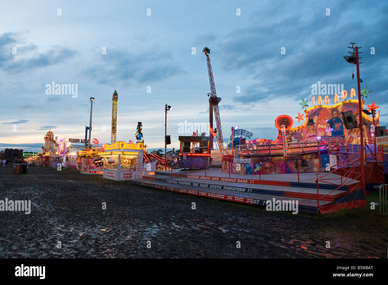 Night time photograph of various rides at a fun fair (specifically 'The ...