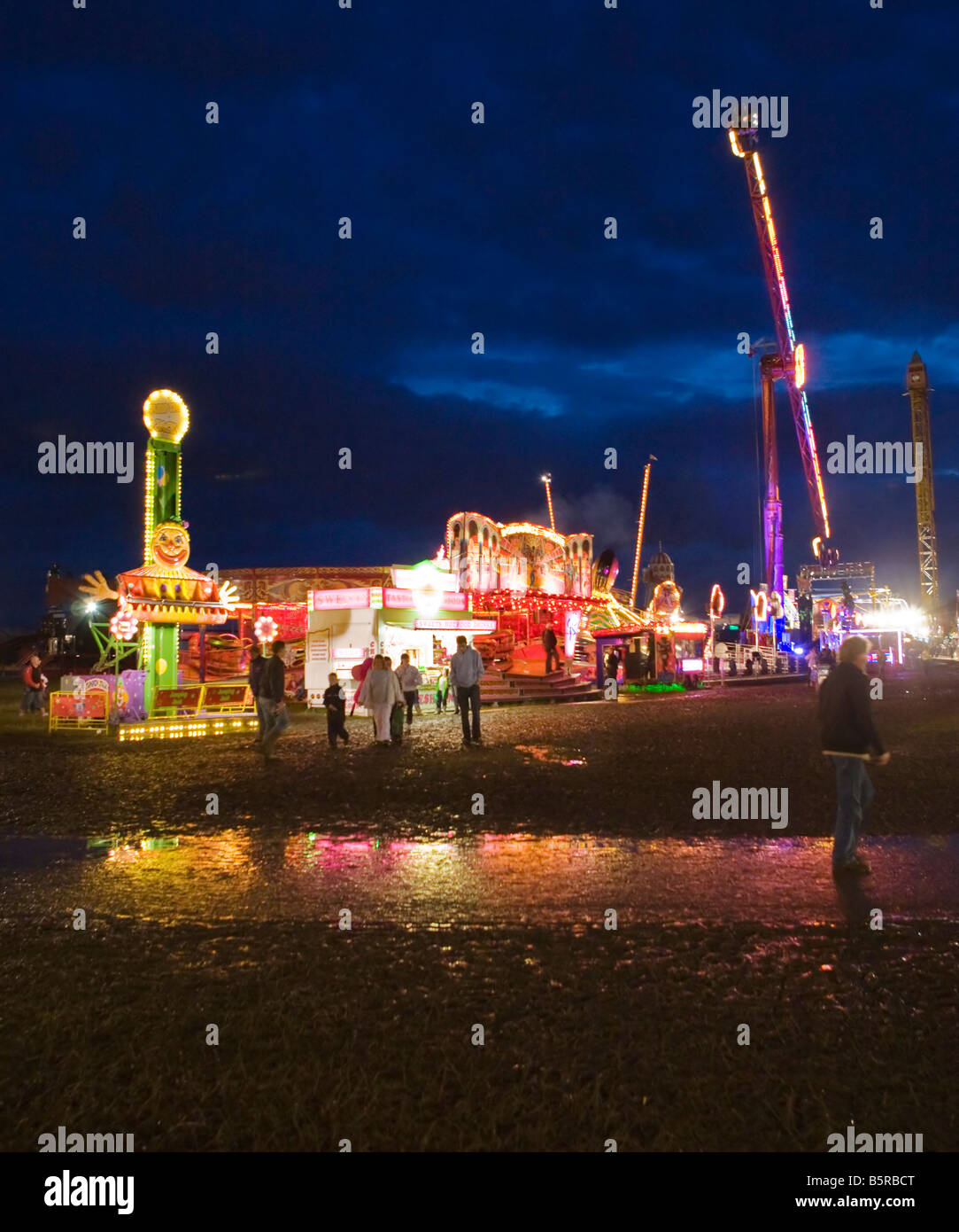 Night time photograph of various rides at a fun fair (specifically 'The ...