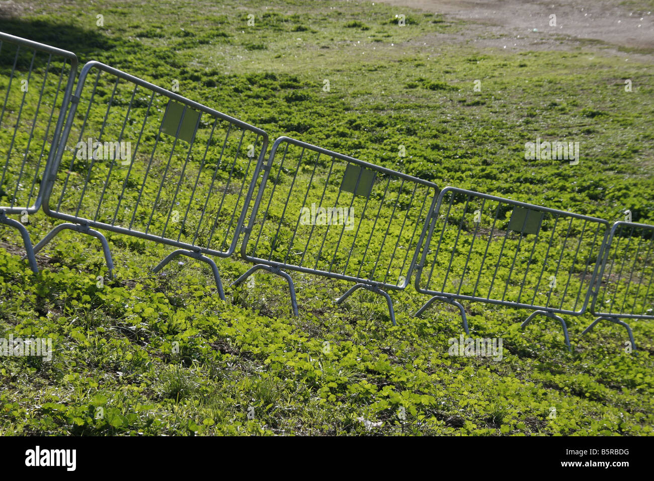 rows of many metal crowd control barriers gates in field Stock Photo ...
