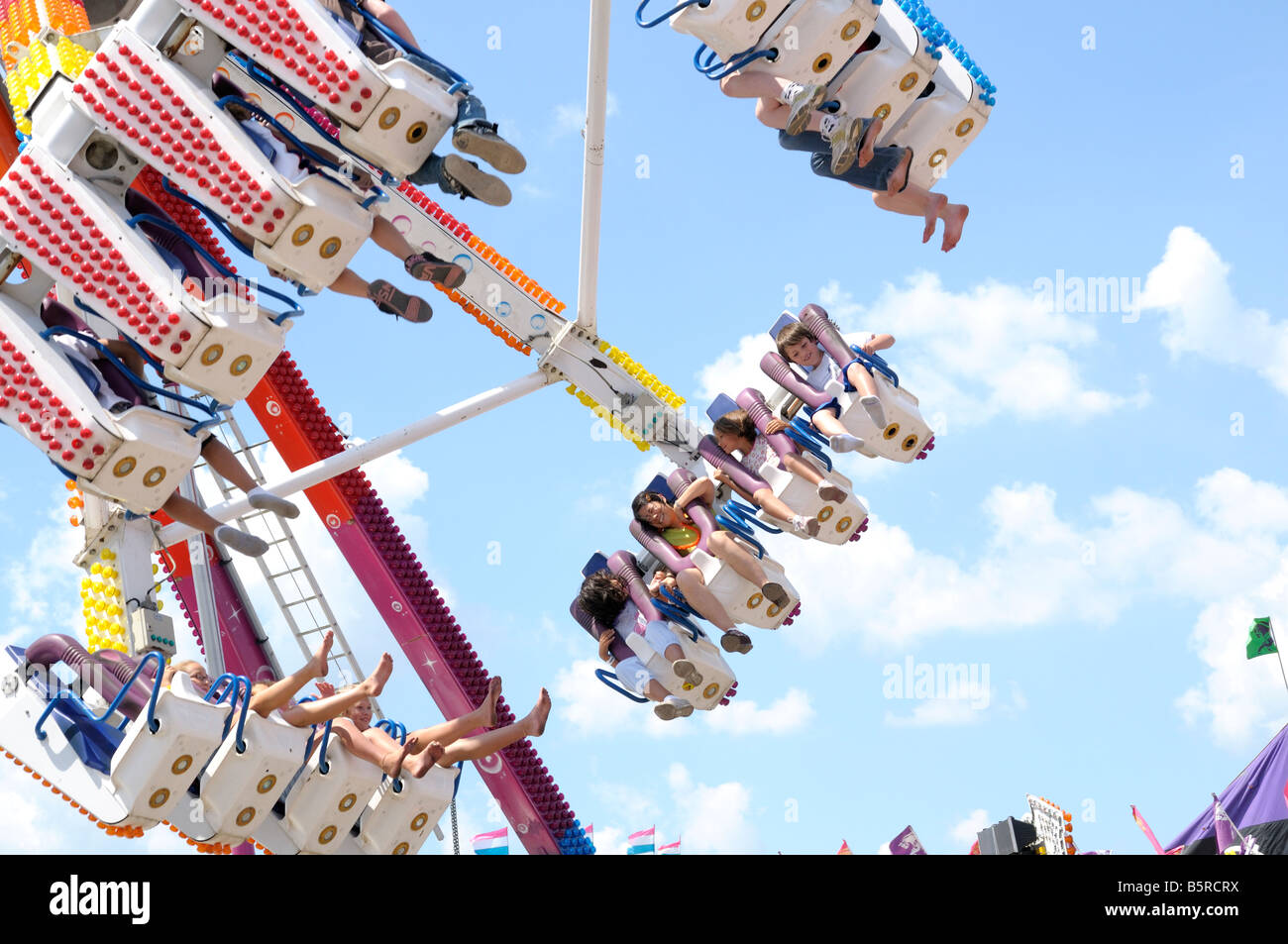 people riding the carnival ride named "Freak Out"at a festival in ...