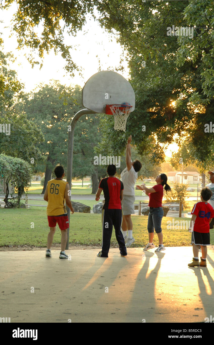 Group of children playing basketball hi-res stock photography and ...