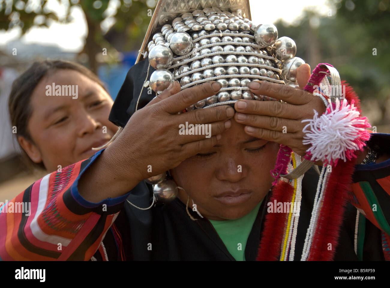 Akha hill tribe woman getting dressed in her traditional costume in a ...