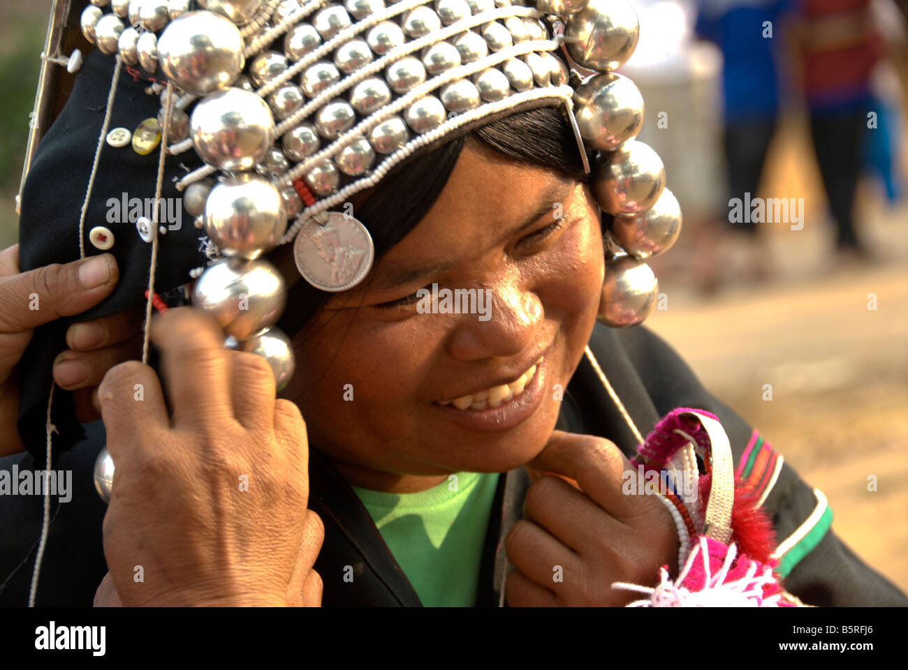 Akha hill tribe woman getting dressed in her traditional costume in a ...