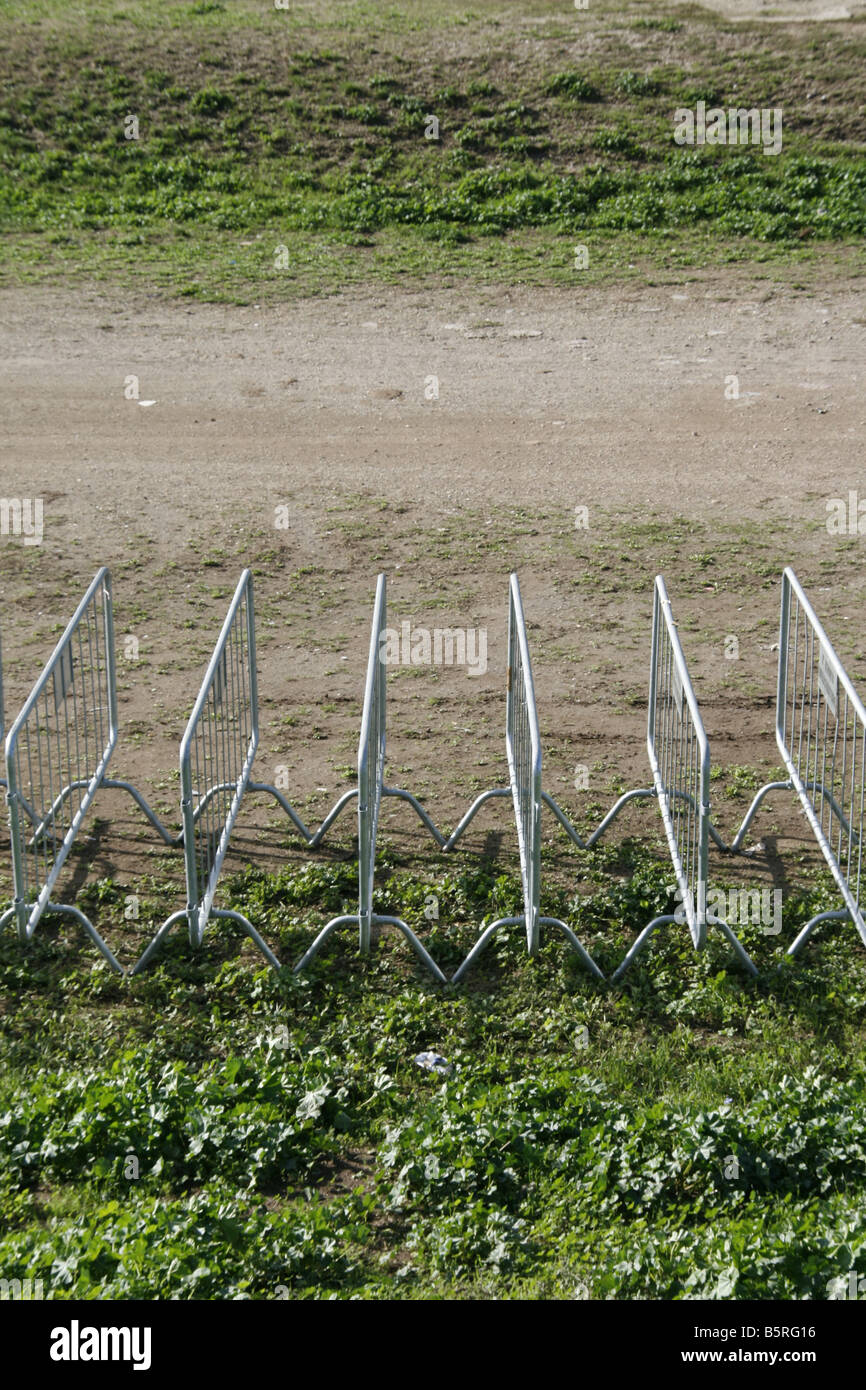 rows of many metal crowd control barriers gates in field Stock Photo ...