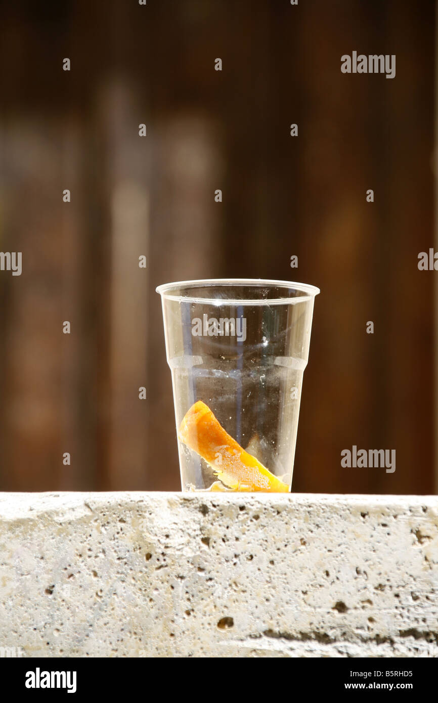 one empty plastic glass on wall by river in sun Stock Photo - Alamy