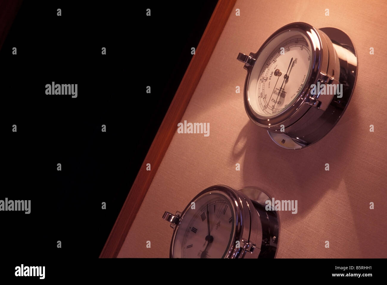 A clock and barometer on mounted on the wall Stock Photo - Alamy