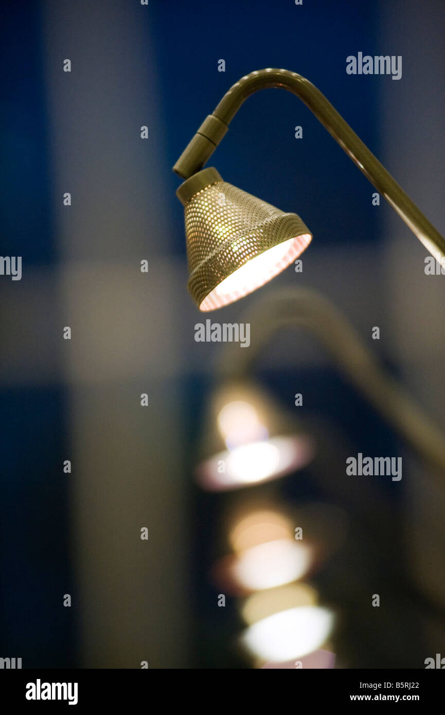 Detail of spotlights illuminating bookshelves at modern library or ...