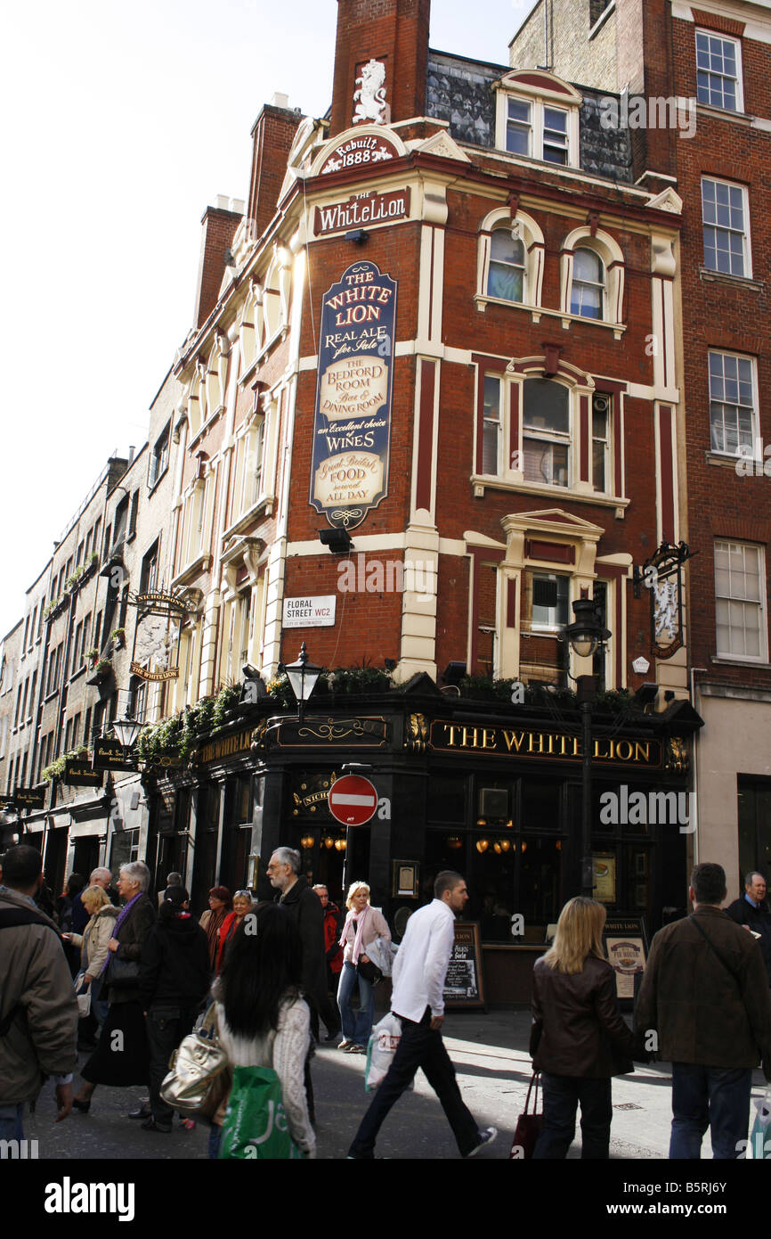People walking on street in London in front of pub Stock Photo - Alamy