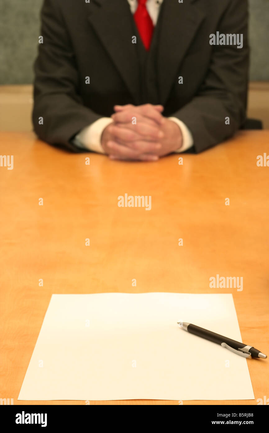 Business man waiting at the desk for you to sign Stock Photo - Alamy