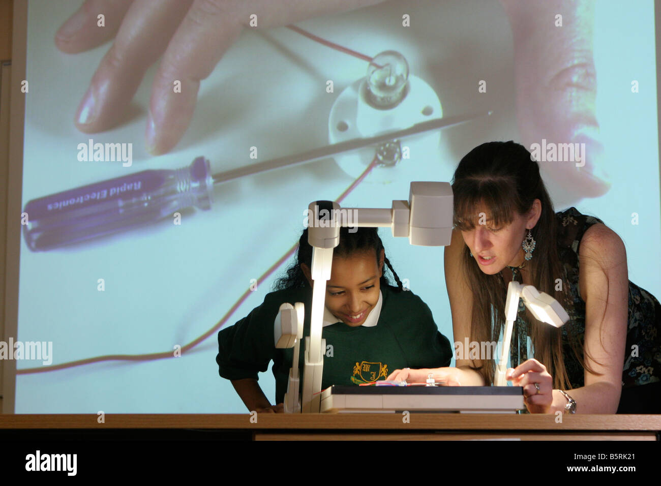 Primary teacher using on screen display Stock Photo - Alamy