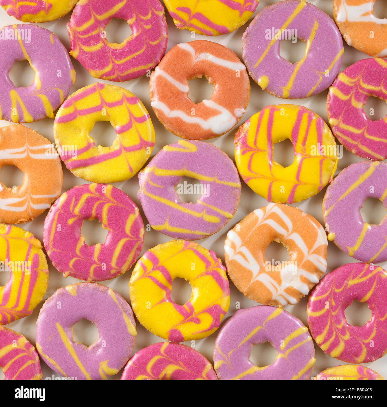 CIRCULAR ROUND PARTY BISCUITS WITH COLOURED ICING Stock Photo - Alamy