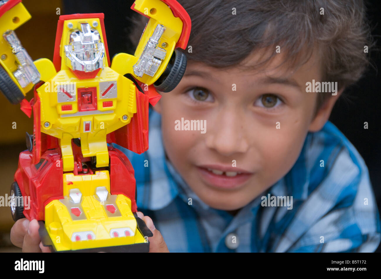 Portrait of boy holding toy Stock Photo - Alamy