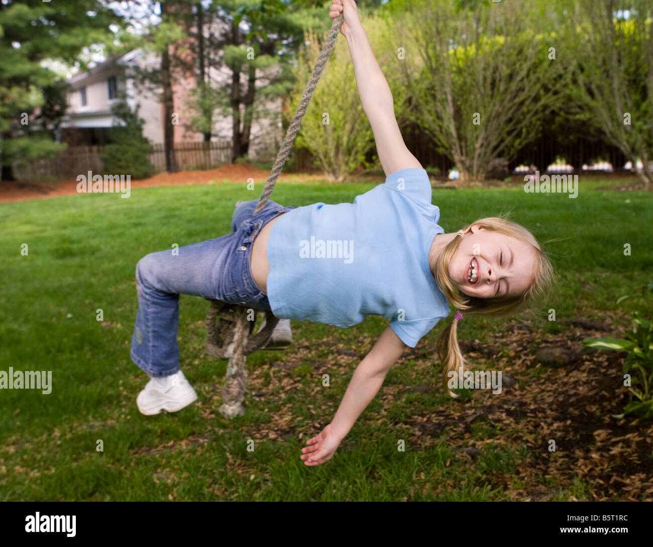 Child on a rope swing hi-res stock photography and images - Alamy