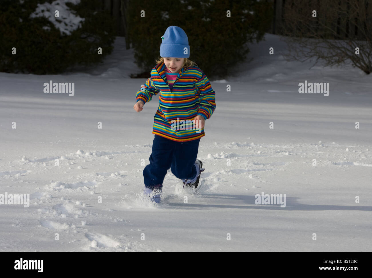 Child running in the snow Stock Photo - Alamy