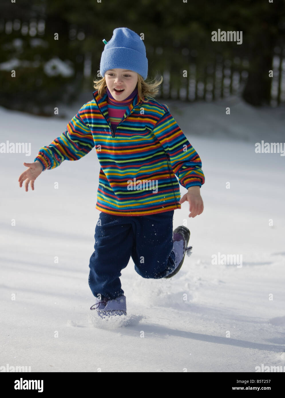 Child running in the snow Stock Photo - Alamy