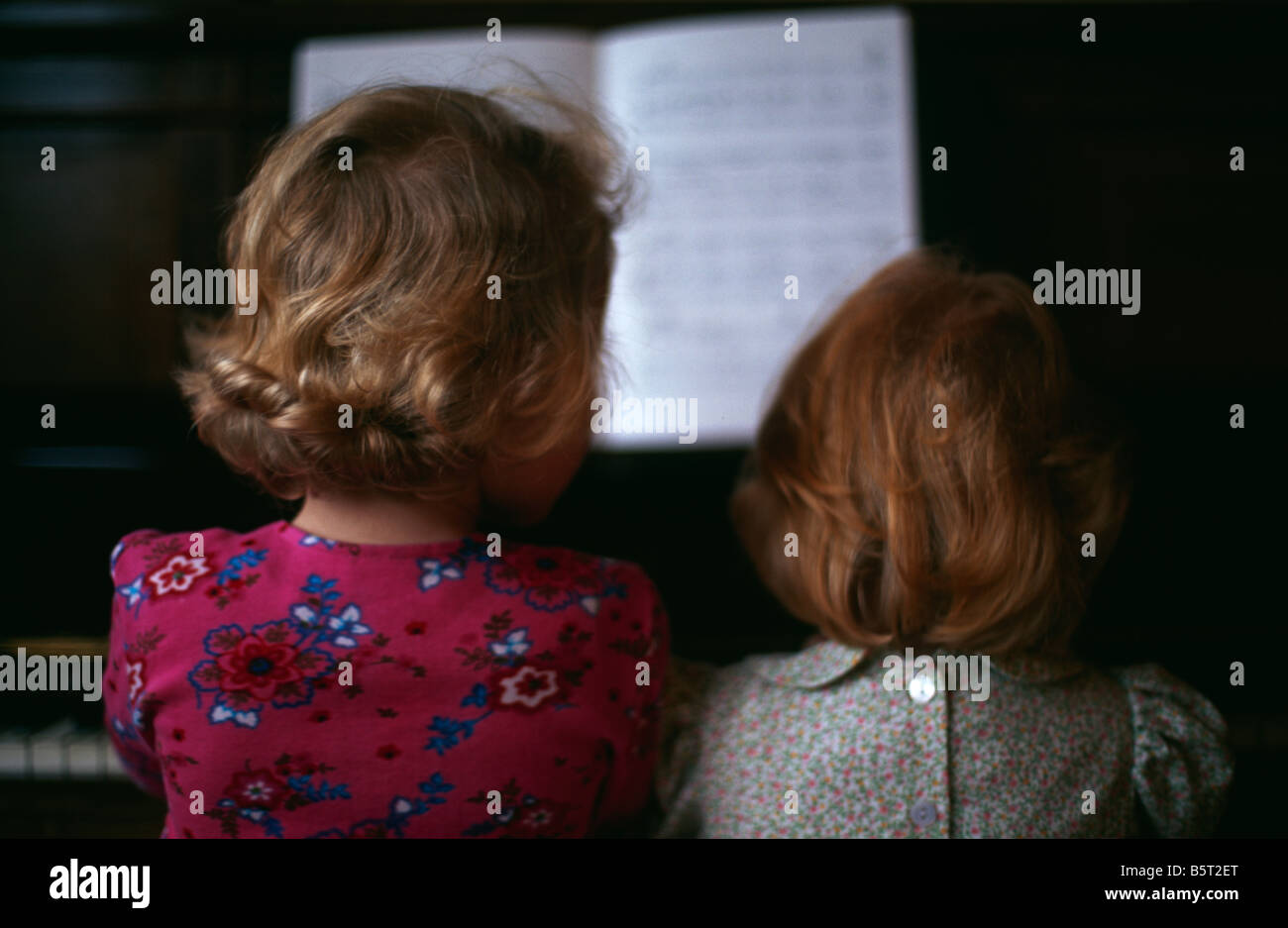 Two young girls playing the piano, UK Stock Photo - Alamy