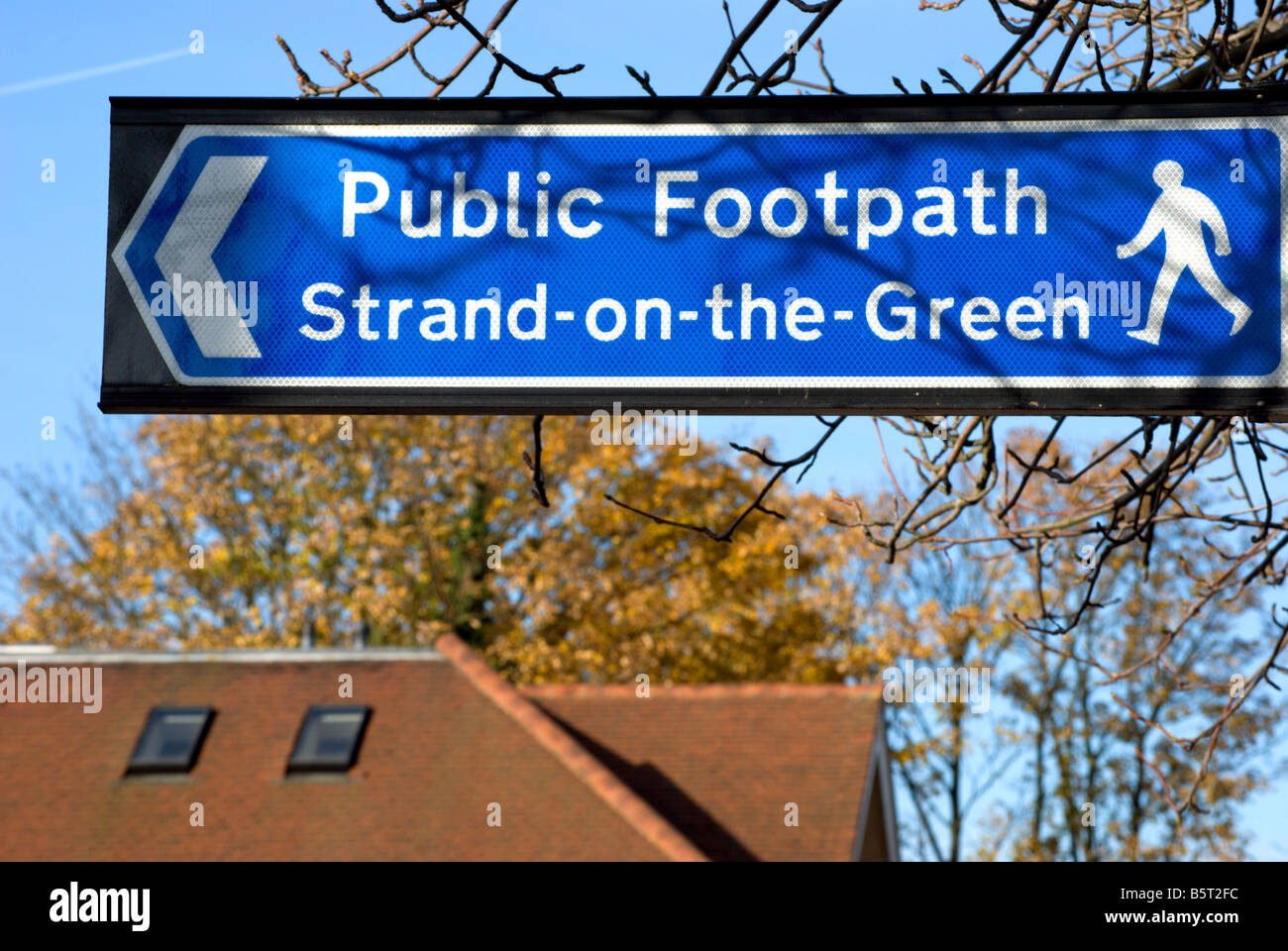 sign indicating a public footpath to strand-on-the-green, beside the ...