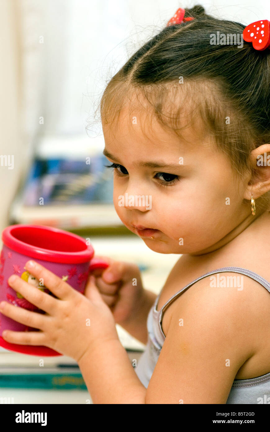 Young girl drinking from beaker Yorkshire UK Stock Photo - Alamy
