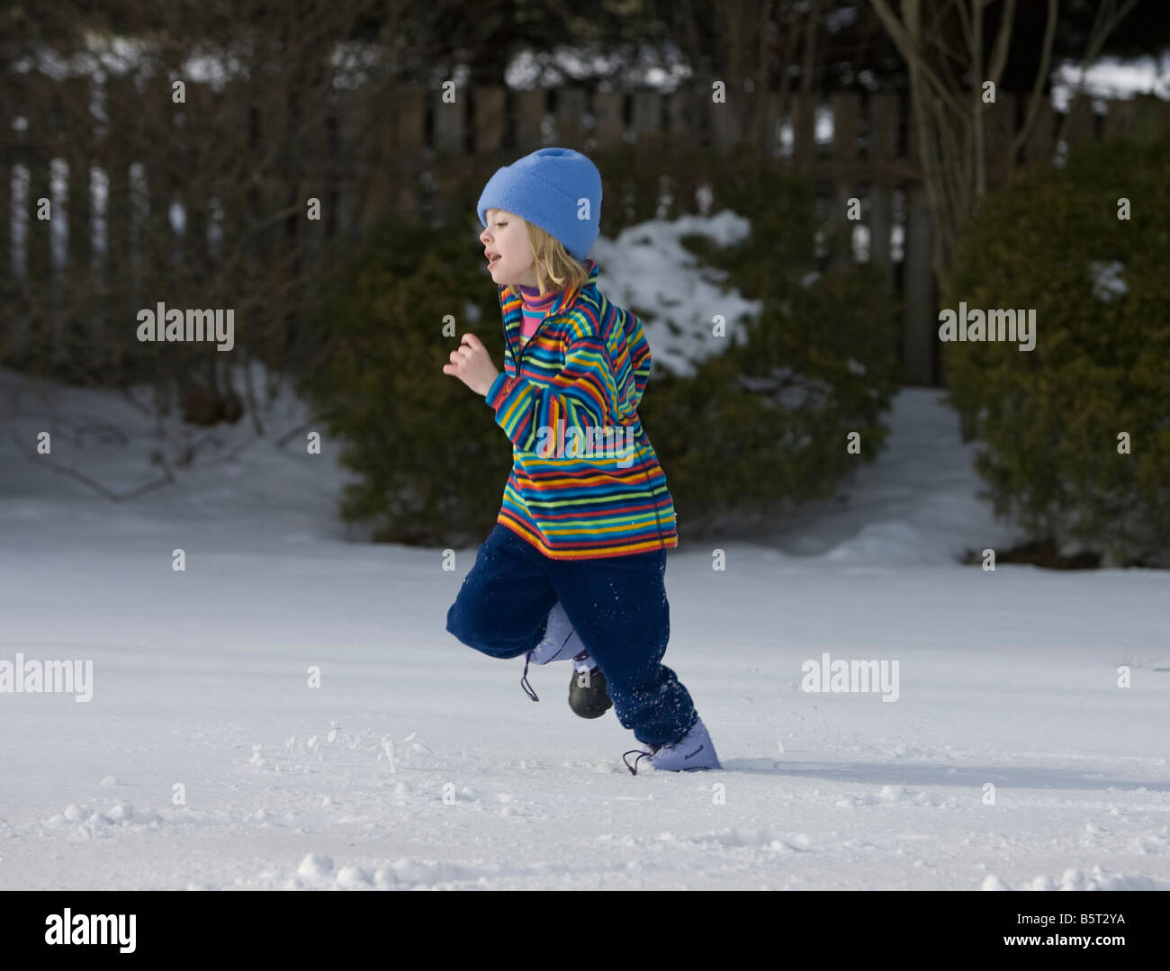 Child running in the snow Stock Photo - Alamy