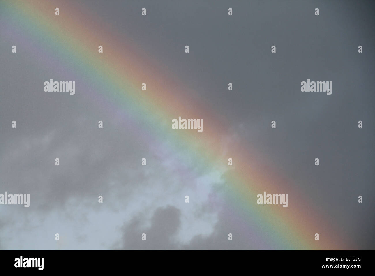 one colourful rainbow arch curve and dark sky Stock Photo - Alamy