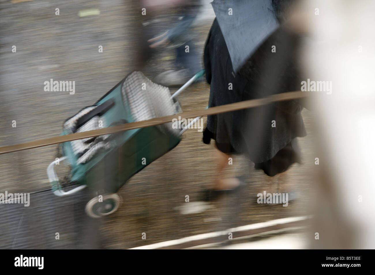 Woman shopping trolley rain hi-res stock photography and images - Alamy