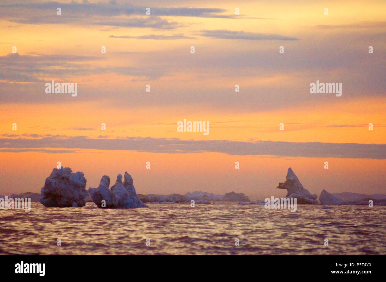 melting shorefast ice in the Beaufort Sea at sunset Arctic Ocean off ...