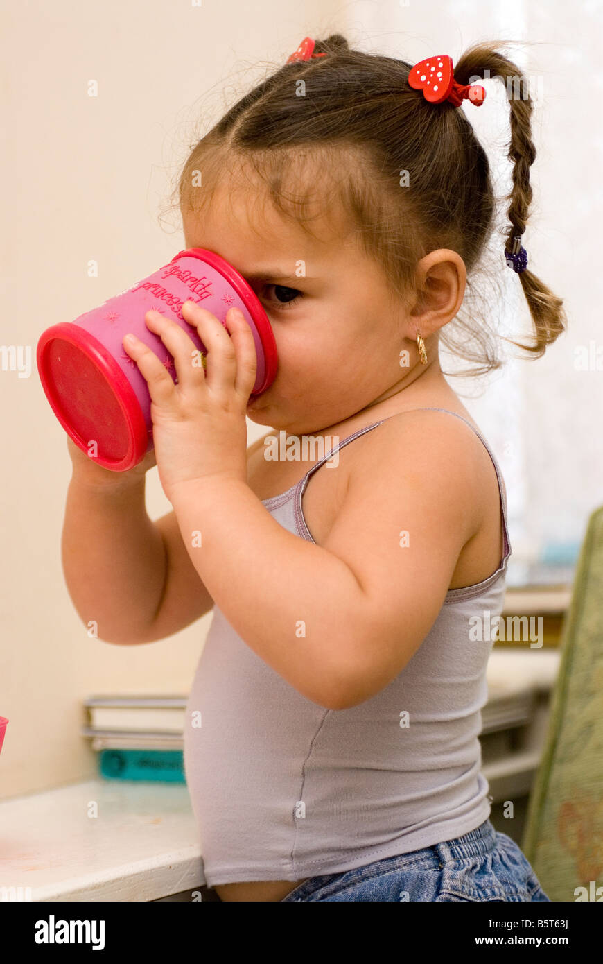 Young girl drinking from beaker Yorkshire UK Stock Photo - Alamy