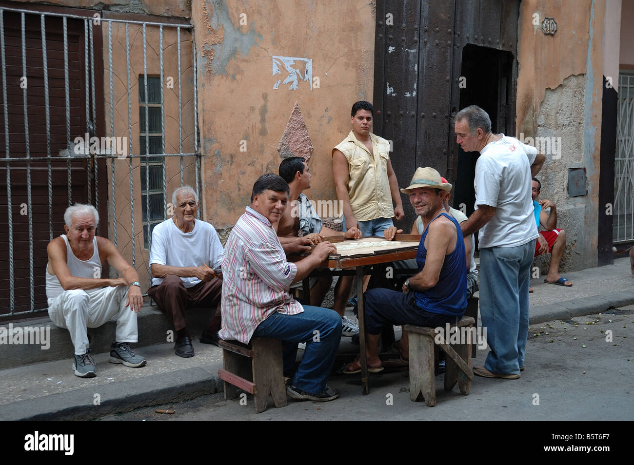 Group of cuban people playing the national hobby "domino" game in a ...