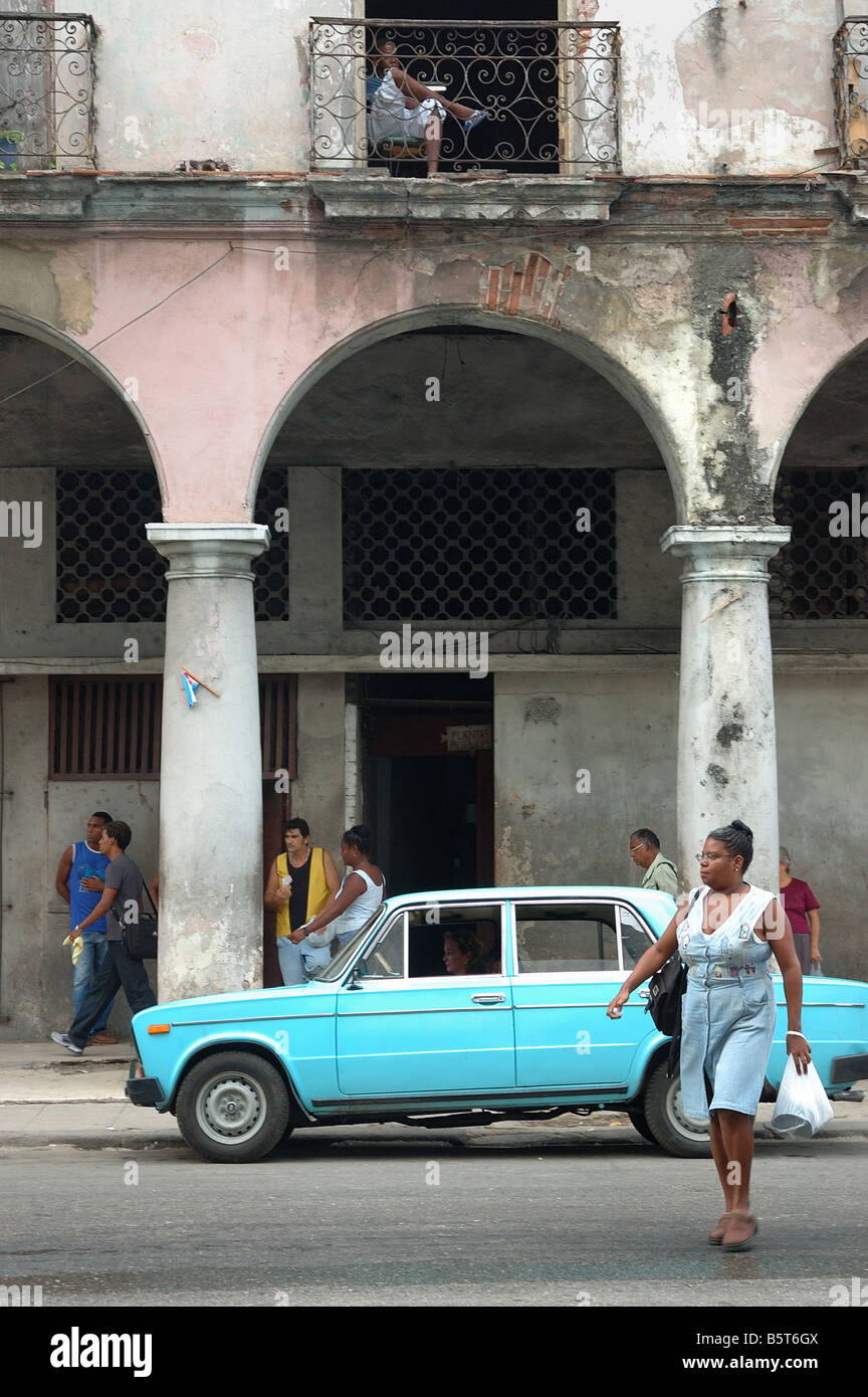 Havana street with typical Lada car crossing by and eroded building in ...