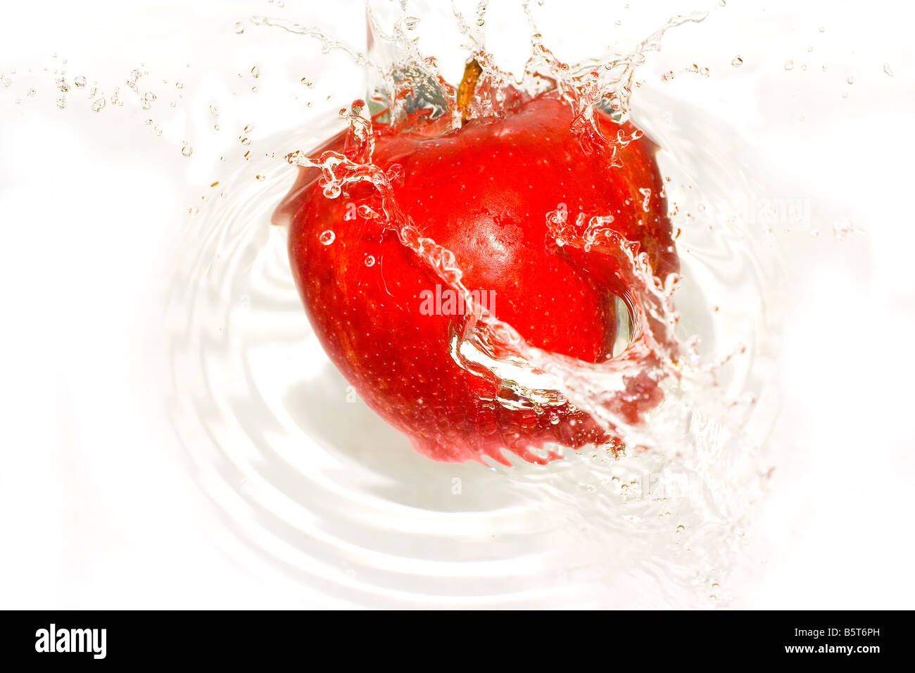 Red apple splashing Stock Photo - Alamy