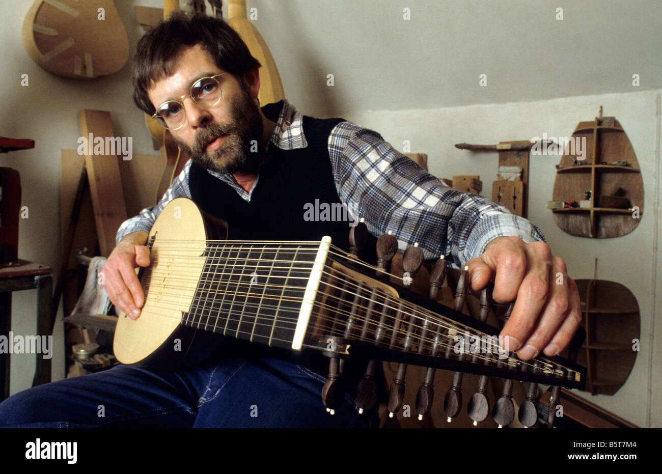 Luthier holding /playing / tuning Lute - UK Stock Photo - Alamy