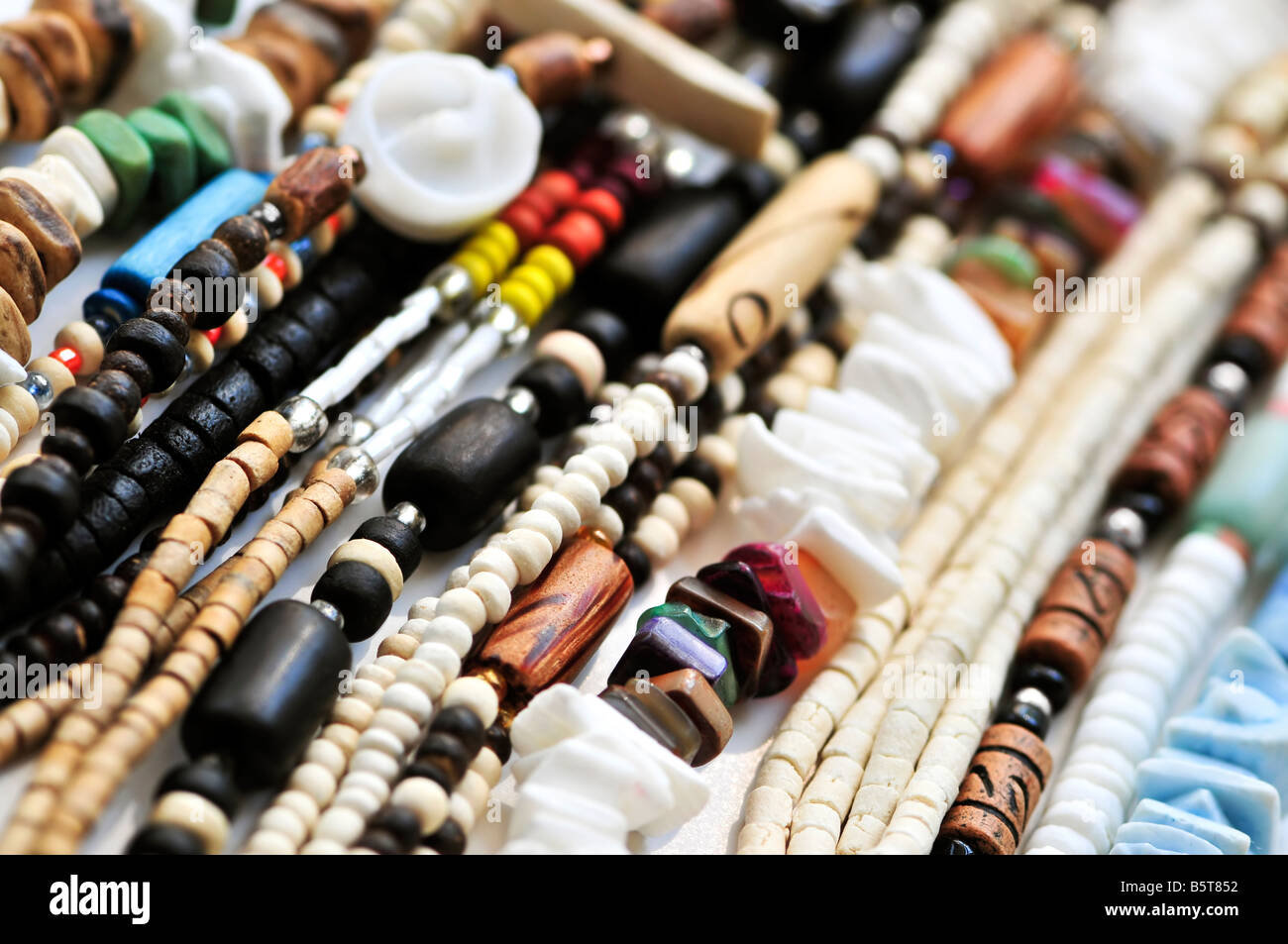 Wood and seashell bead necklaces close up Stock Photo - Alamy