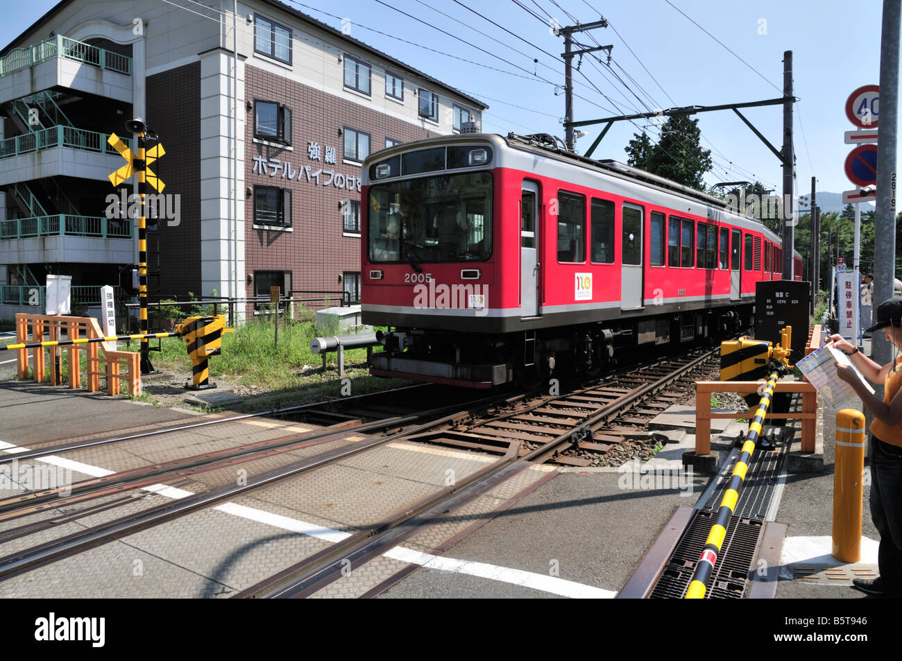 The Hakone Tozan Train arriving at the level crossing at Gora, Hakone ...