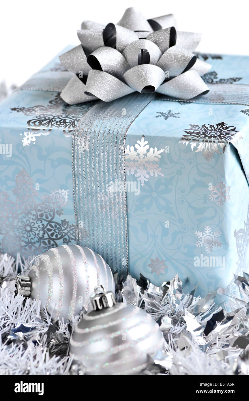 Wrapped gift box with Christmas ornaments on white background Stock ...