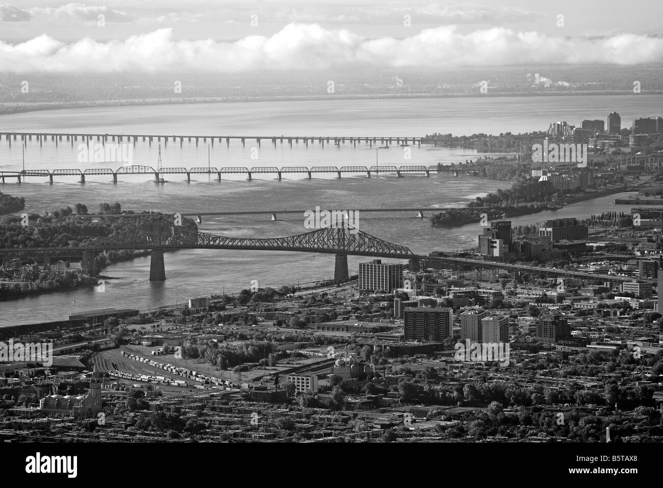 aerial view above Saint Lawrence river with four bridges at Montreal ...