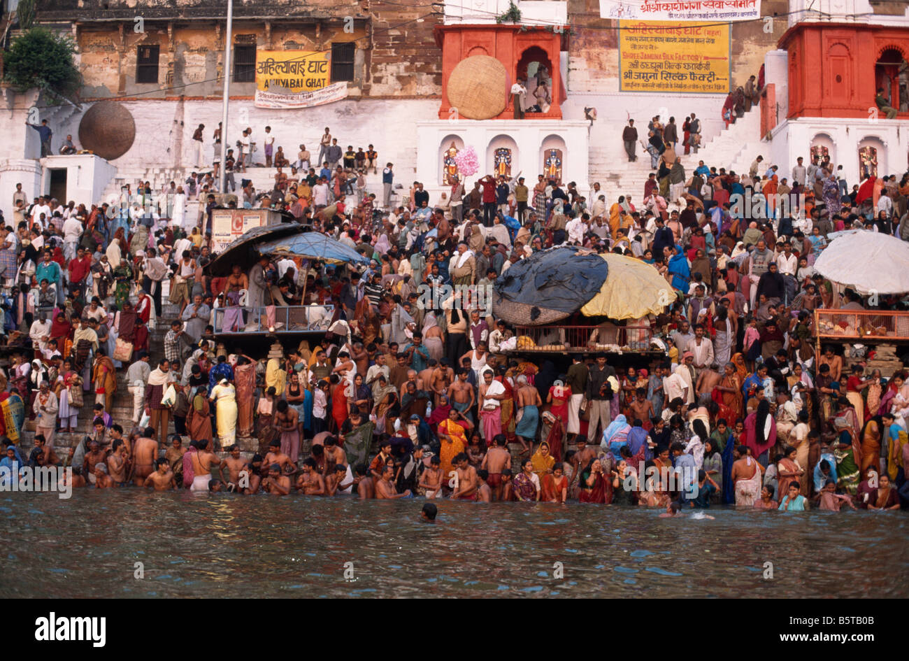 Crowds of pilgrims on the ghats of the river Ganges at Varanasi during ...