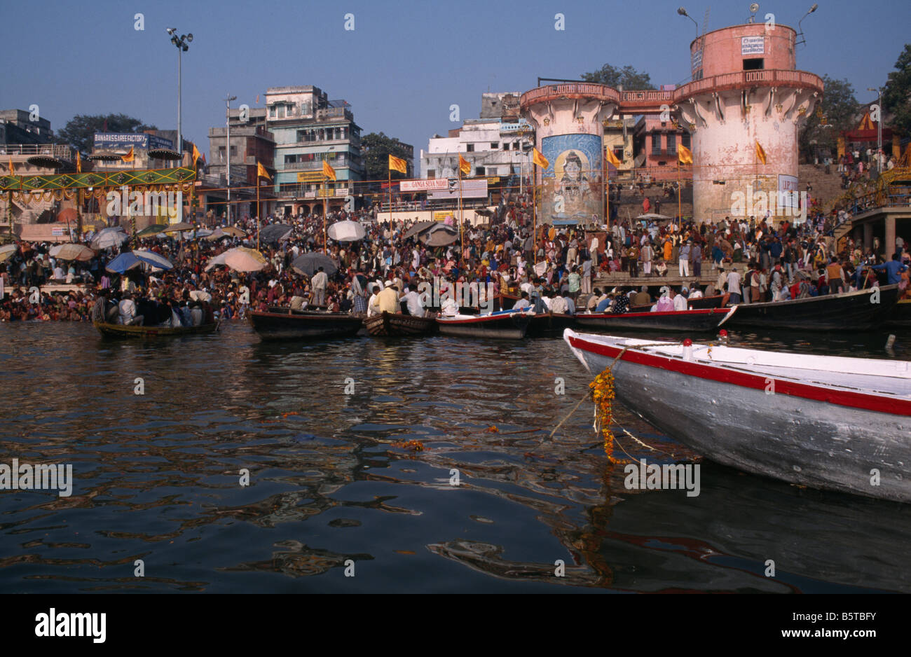 Crowds of pilgrims on the ghats of the river Ganges at Varanasi during ...