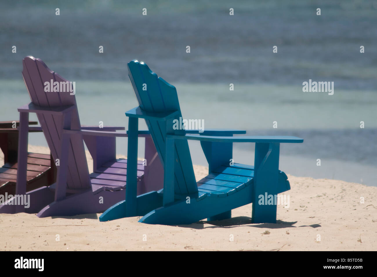 Colorful Adirondack beach chairs overlooking Caribbean beach and sea ...