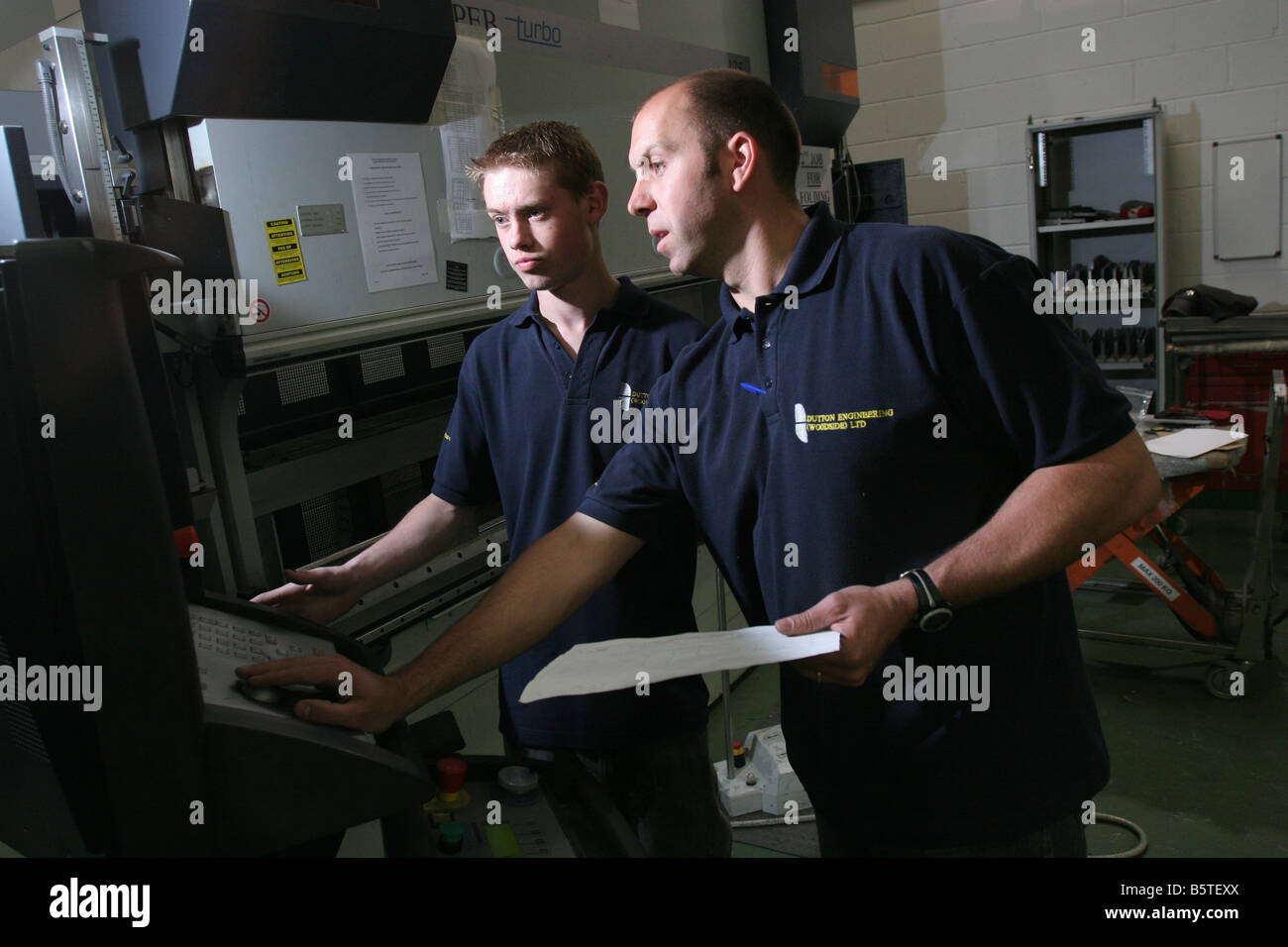 modern apprentice at work with mentor on a CAD machine Stock Photo - Alamy