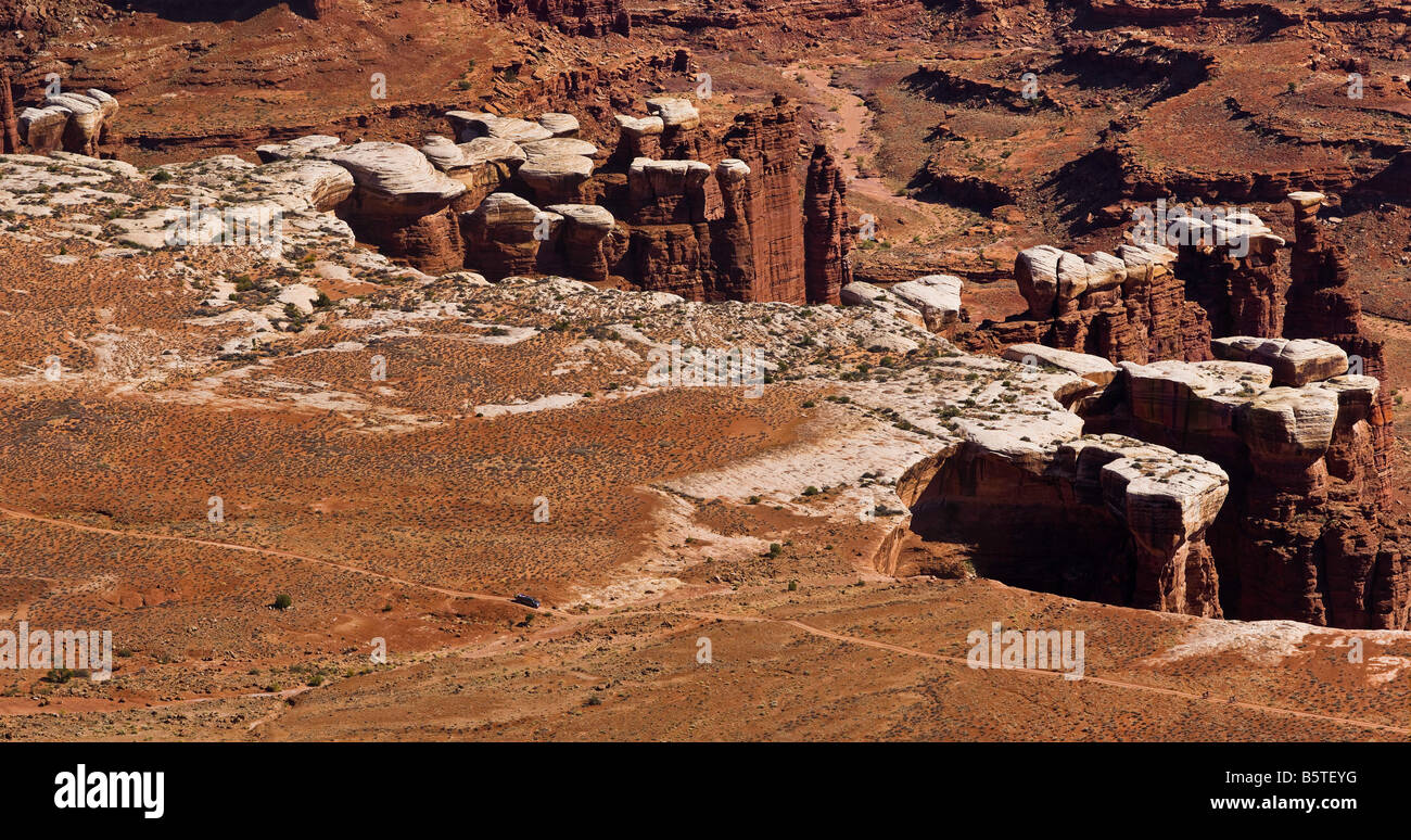 a truck on the White Rim Road by the Monument Basin in Canyonlands ...