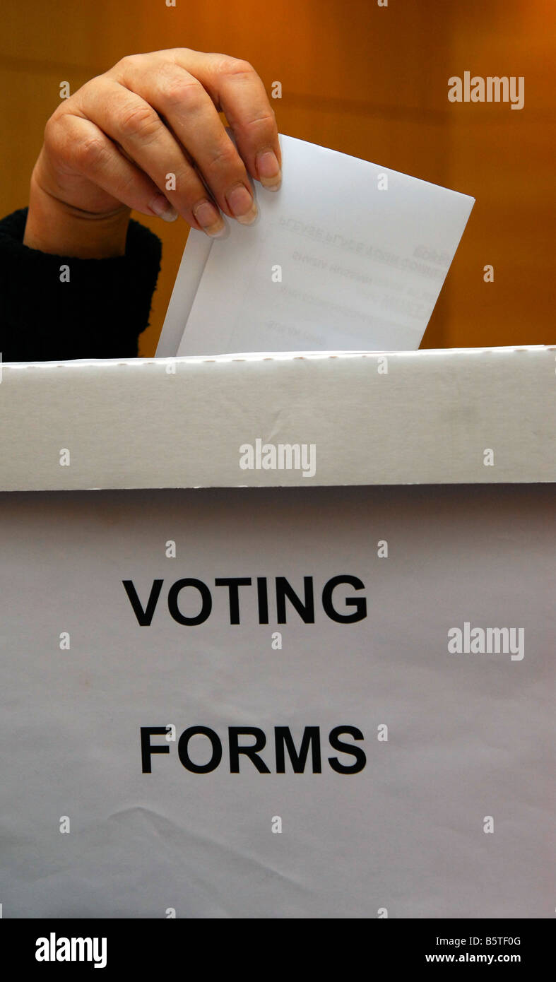 Woman putting voting form in election box at a charity event, London ...